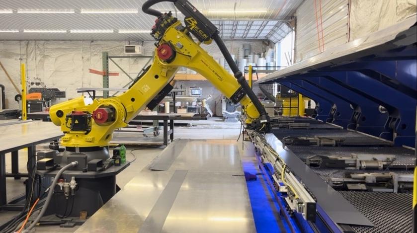 Robotic system customized for use with folding machines